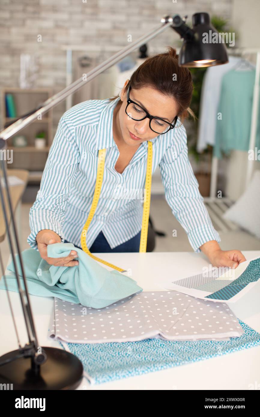 fashion designer woman working on her designs in the studio Stock Photo ...