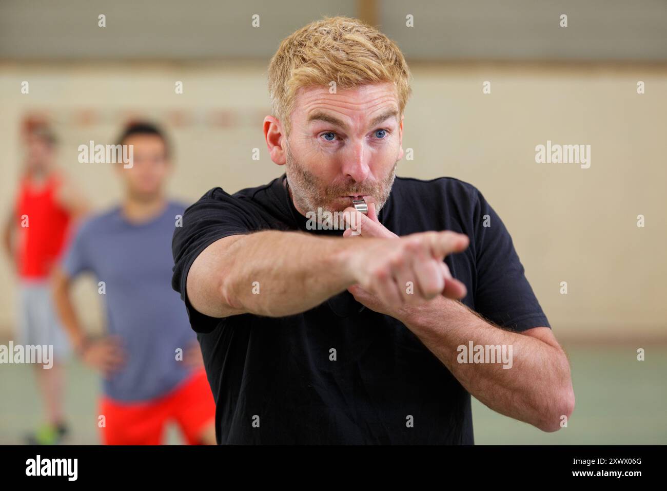 angry referee blowing a whistle and pointing with his hand Stock Photo ...