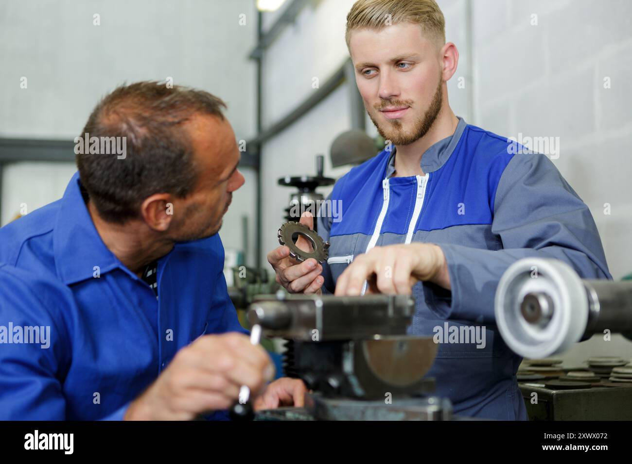two mechanics working on a car Stock Photo - Alamy