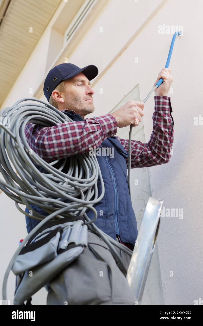 a male electrician holding cables Stock Photo - Alamy