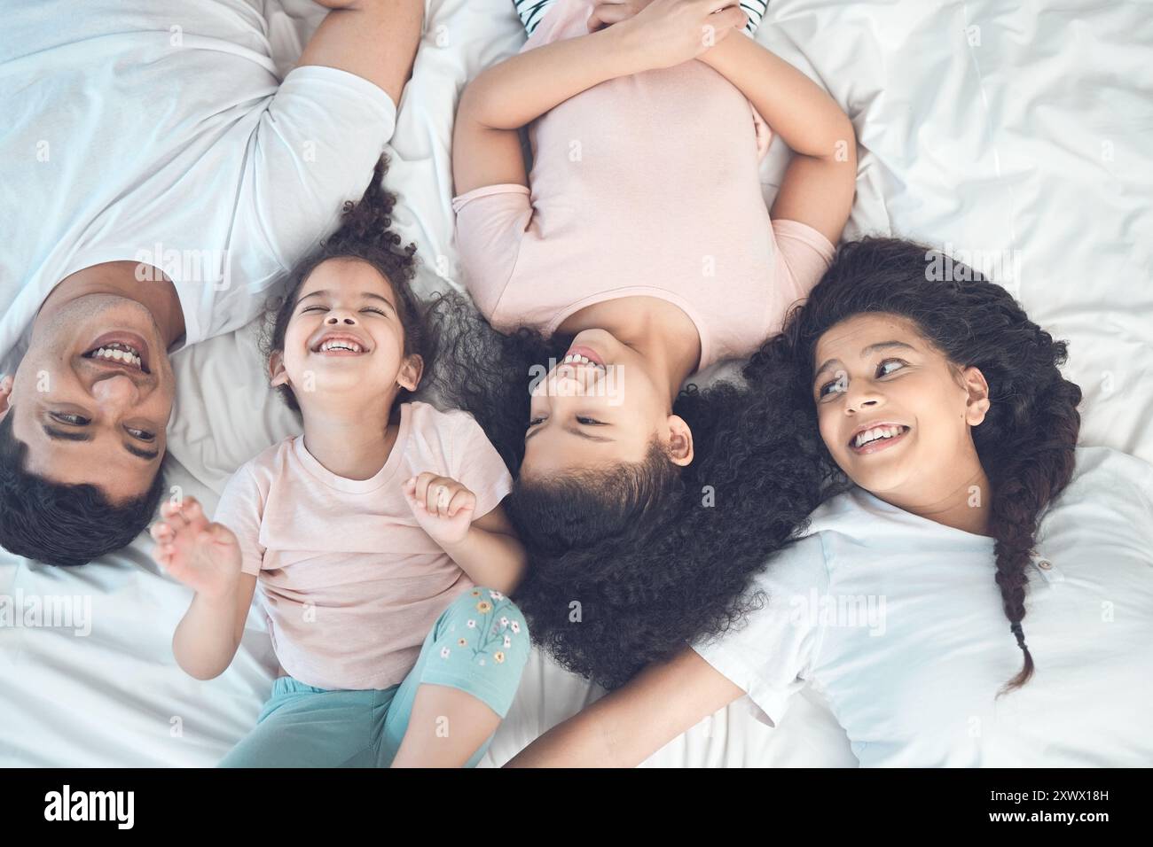 Bed, happy and above of parents and children for relax, rest and ...