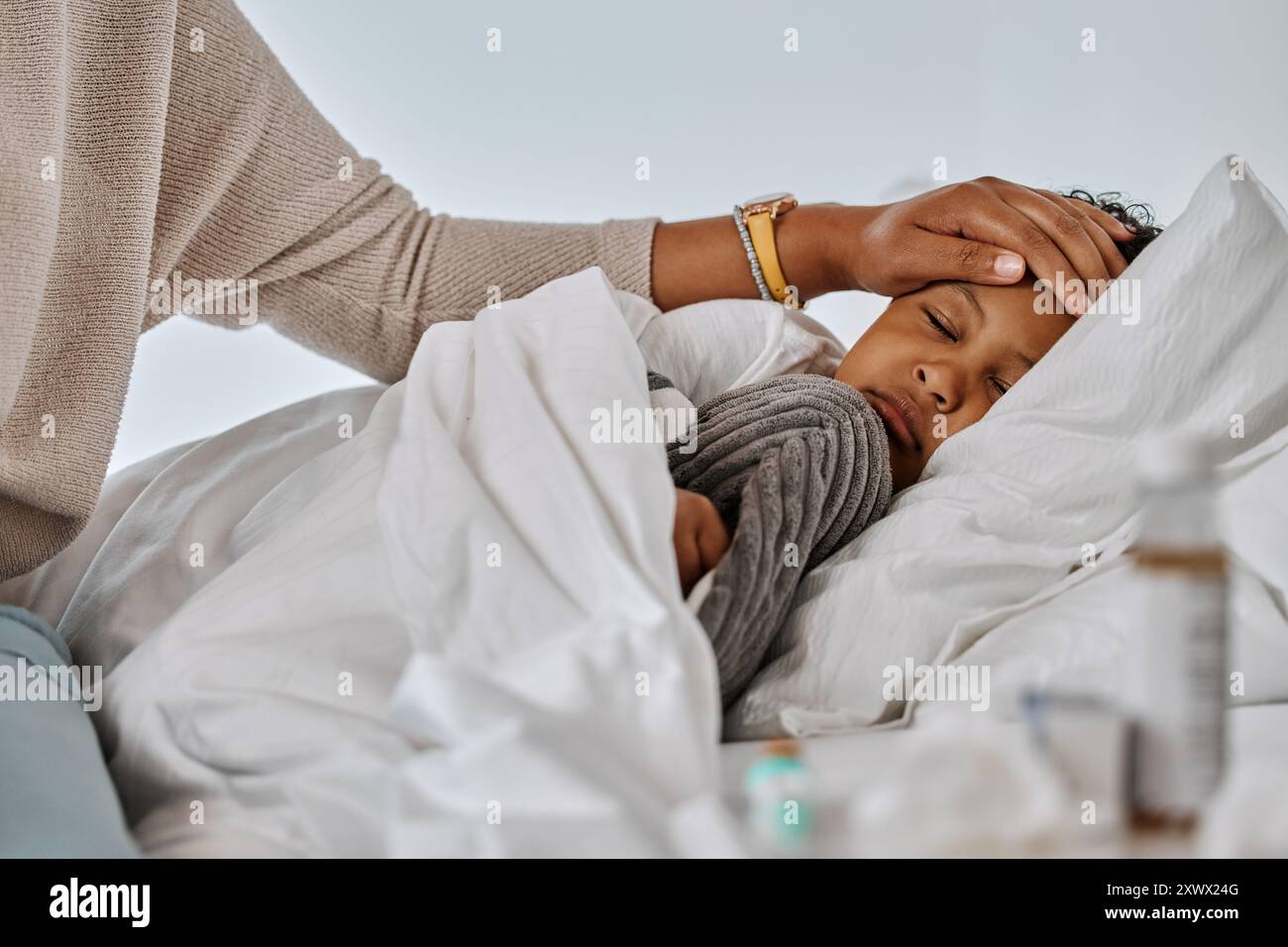 Sick, child and hand with fever in bedroom for flu infection, illness and sleeping with blankets ...