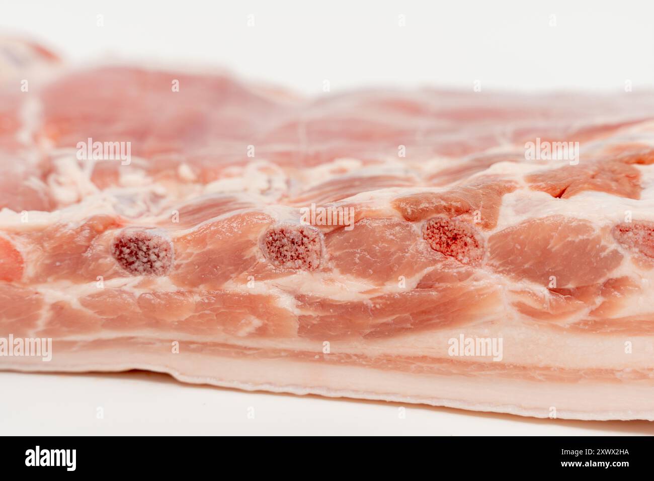 A piece of meat with a lot of red spots on it Pork meat isolated on a ...