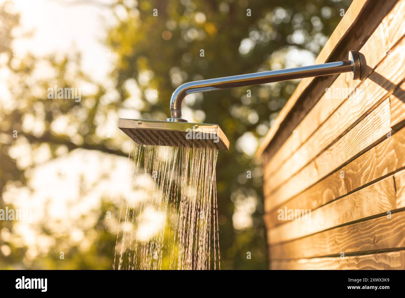 Outdoor shower with flowing water at sunset for showering before and ...