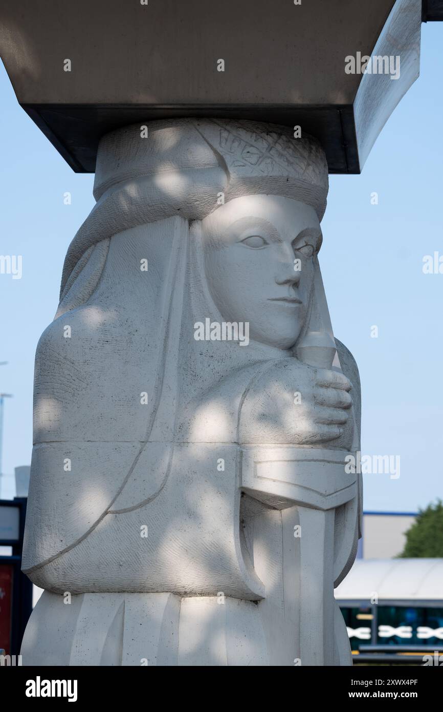 Figure supporting town sign, Wednesbury, West Midlands, England, UK ...