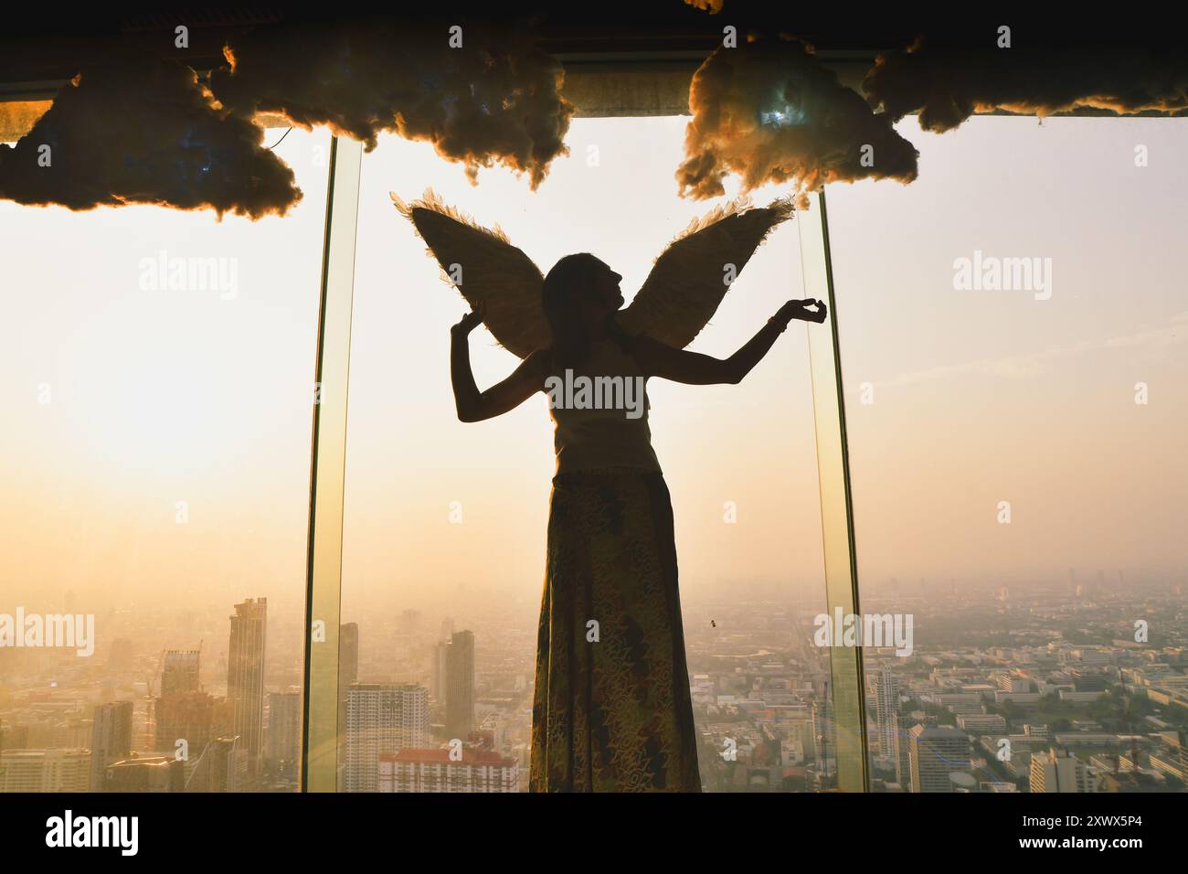 Isolated young caucasian woman pose by wings as angel in Baiyoke Sky ...