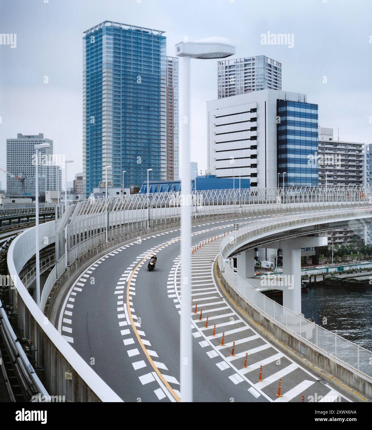 A motorcyclist driving on the Rainbow Bridge, connecting Odaiba and ...