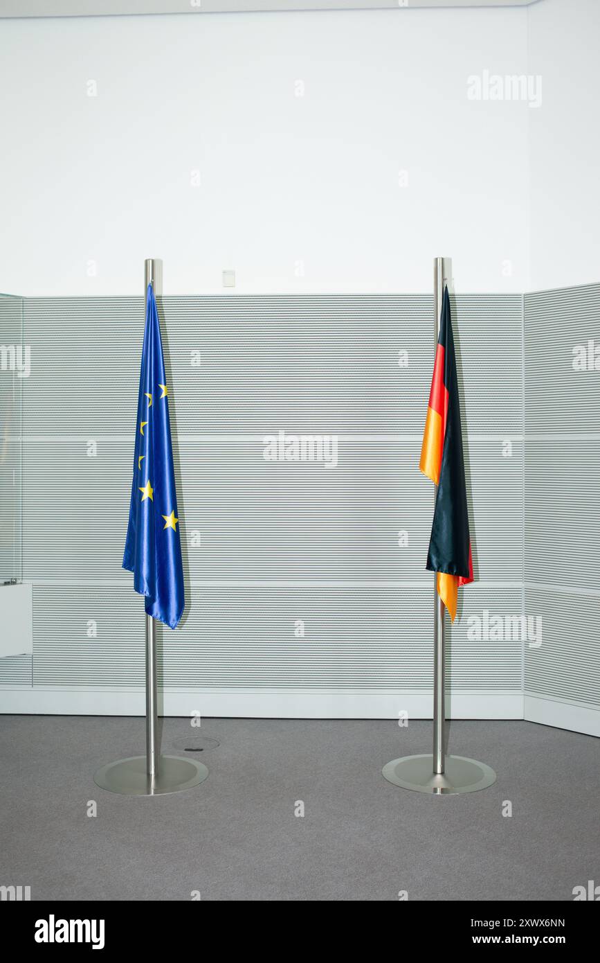 Photograph of European Union and German flags standing prominently side ...