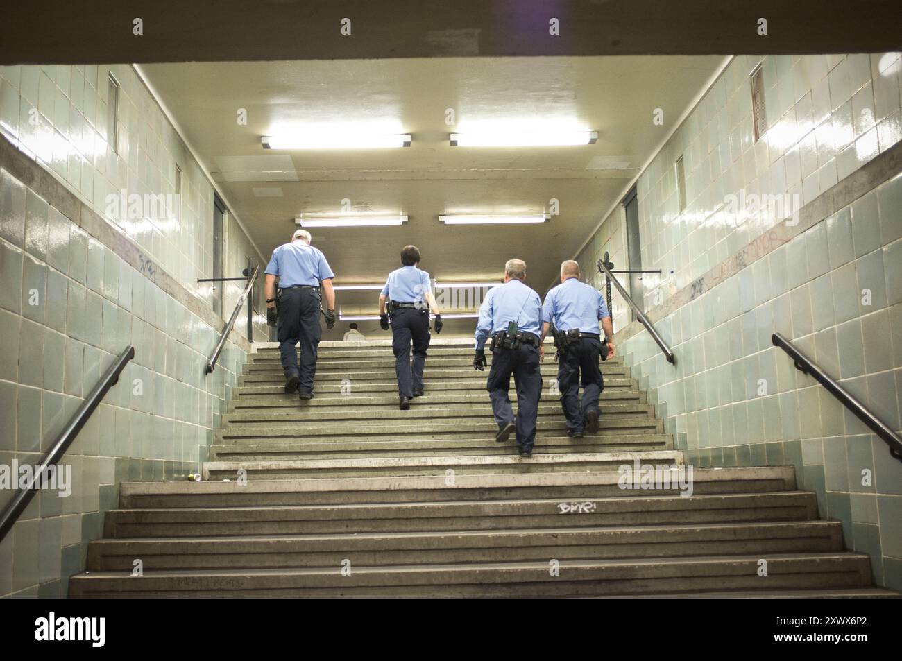 Security officers patrolling a Berlin U-Bahn station, emphasizing the ...
