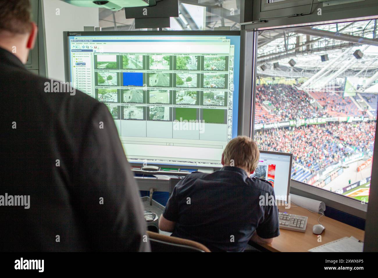 Security personnel monitor live surveillance footage in the control ...