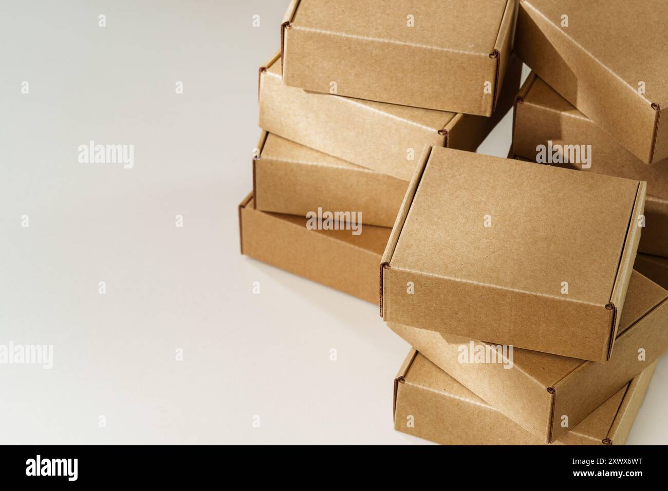 Stacked Brown Cardboard Boxes on White Surface Stock Photo - Alamy
