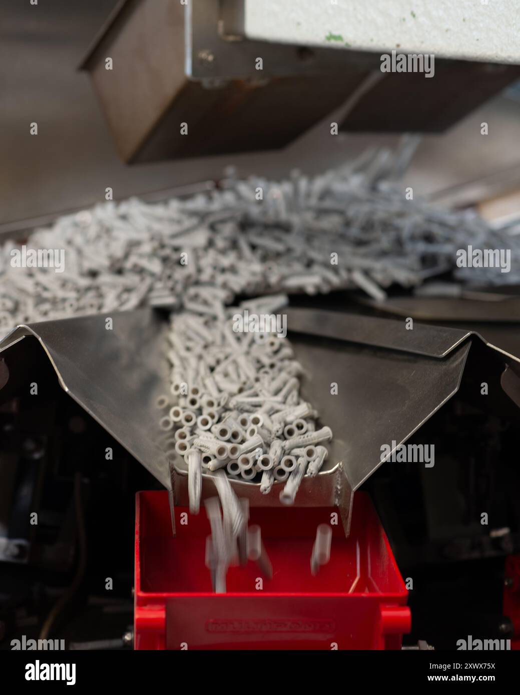 Detailed view of plastic wall plugs being processed at the Fischerwerke ...