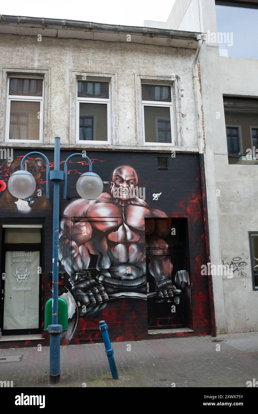 A striking piece of street art depicting a powerful muscular warrior ...