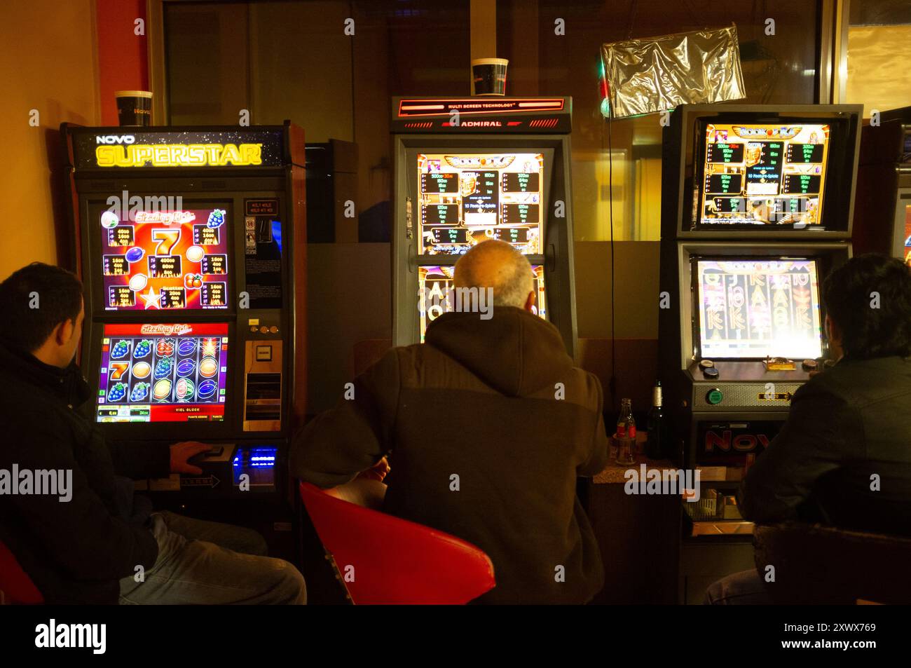 Dimly lit scene captures individuals hi-res stock photography and ...