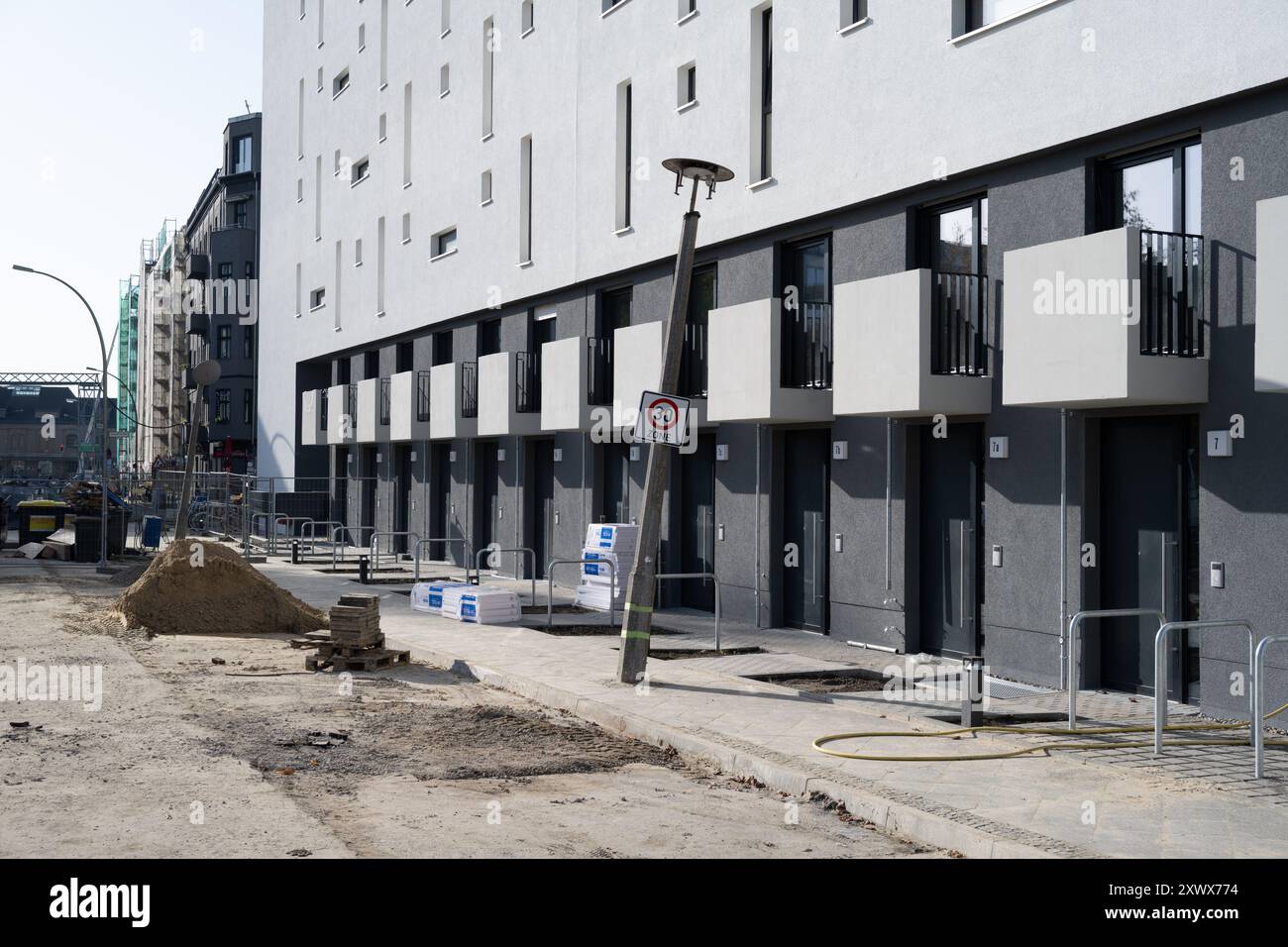An old, broken GDR streetlight stands amidst a newly constructed ...