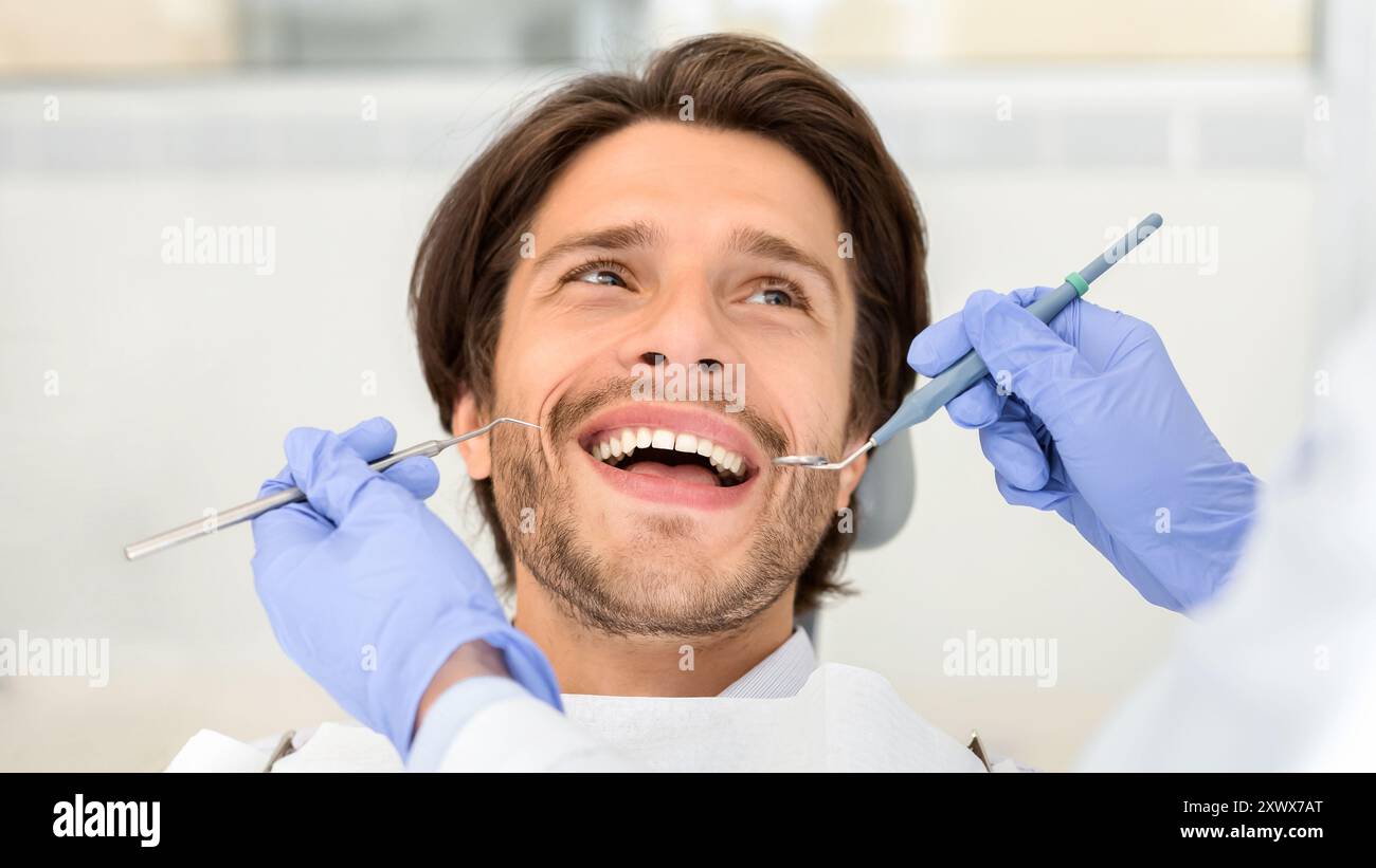 Portrait of handsome smiling man attending dentist Stock Photo - Alamy