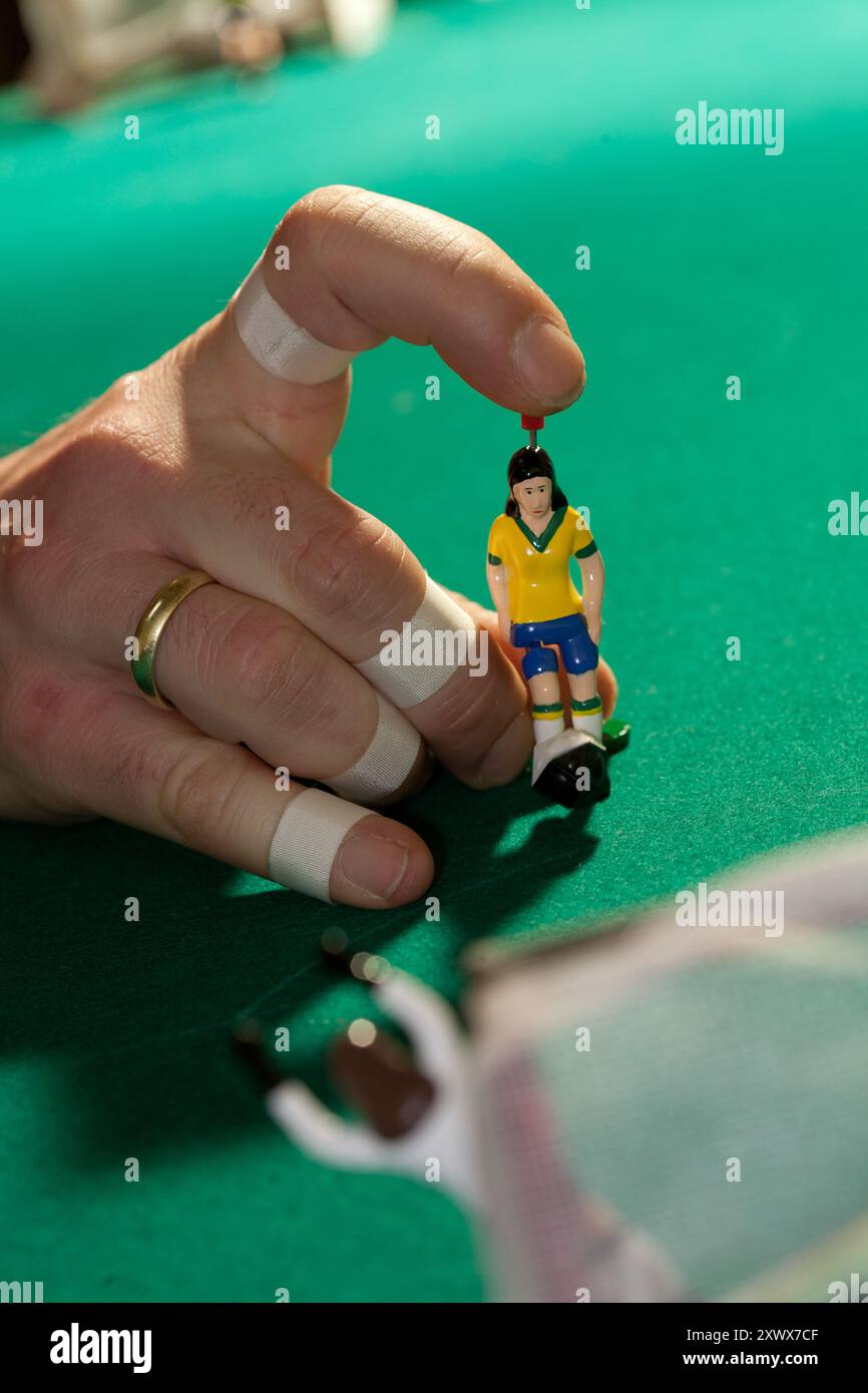 Close-up of a hand holding the first female Tipp-Kick figure during a ...
