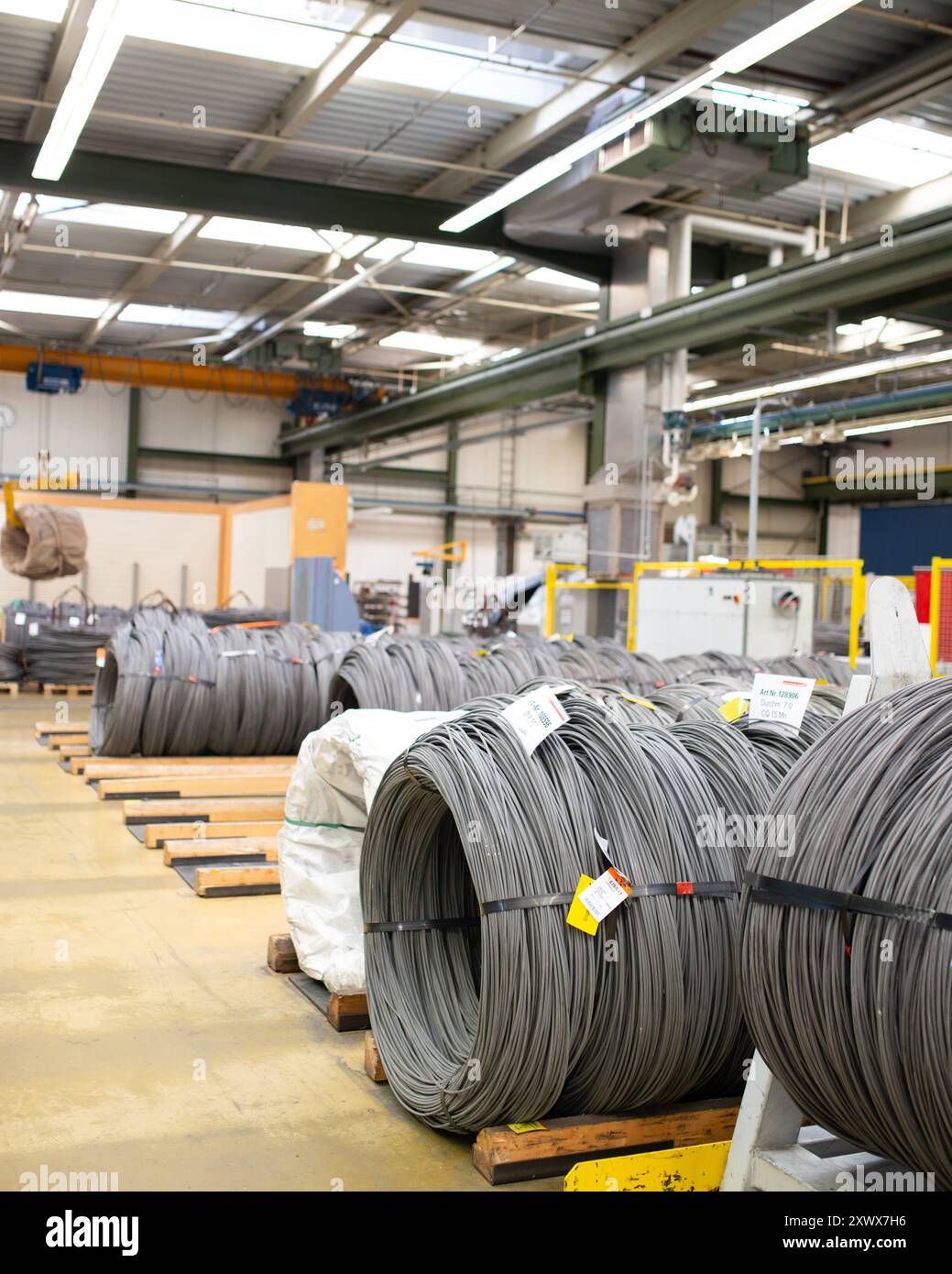 Interior view of a manufacturing facility featuring large coils of ...
