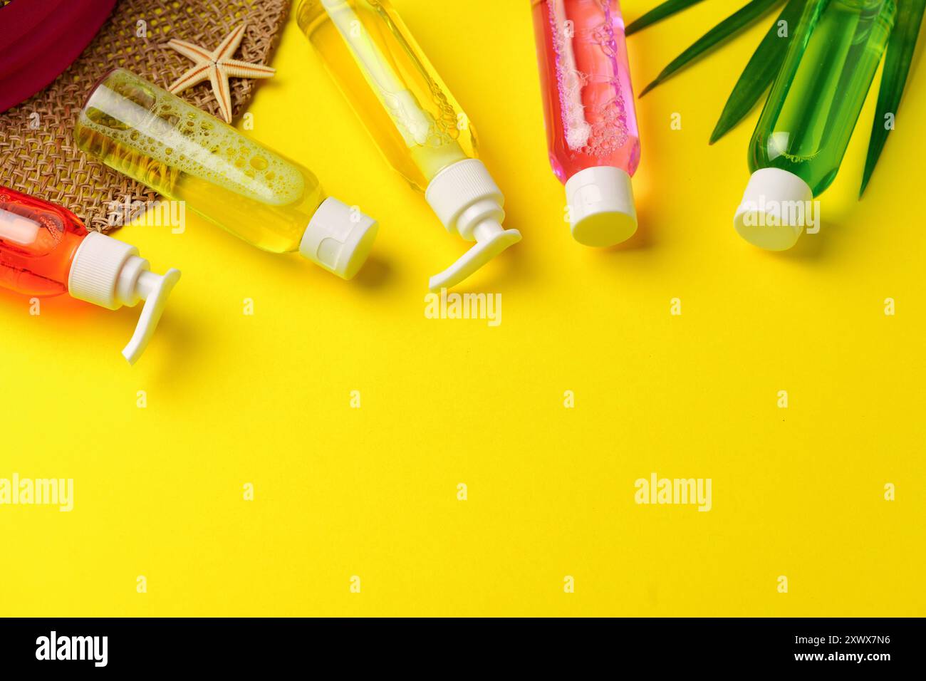Colorful Bottles of Sunscreen With Seashells on Yellow Background Stock ...