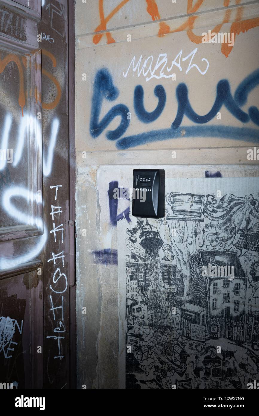 A black key lockbox attached to a graffiti-adorned wall in Berlin ...