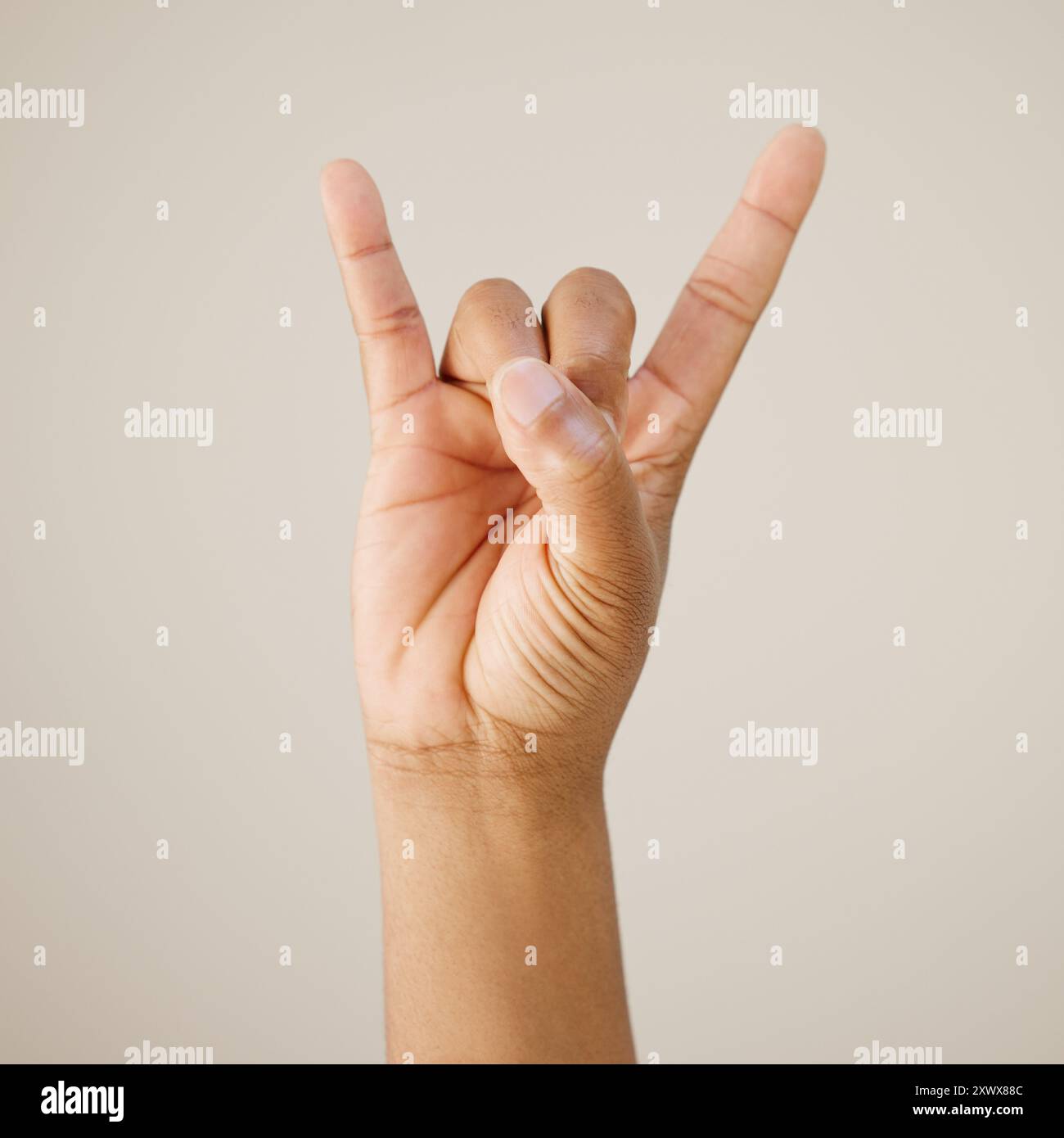 Rock and roll, hands and person with icon in studio background for ...