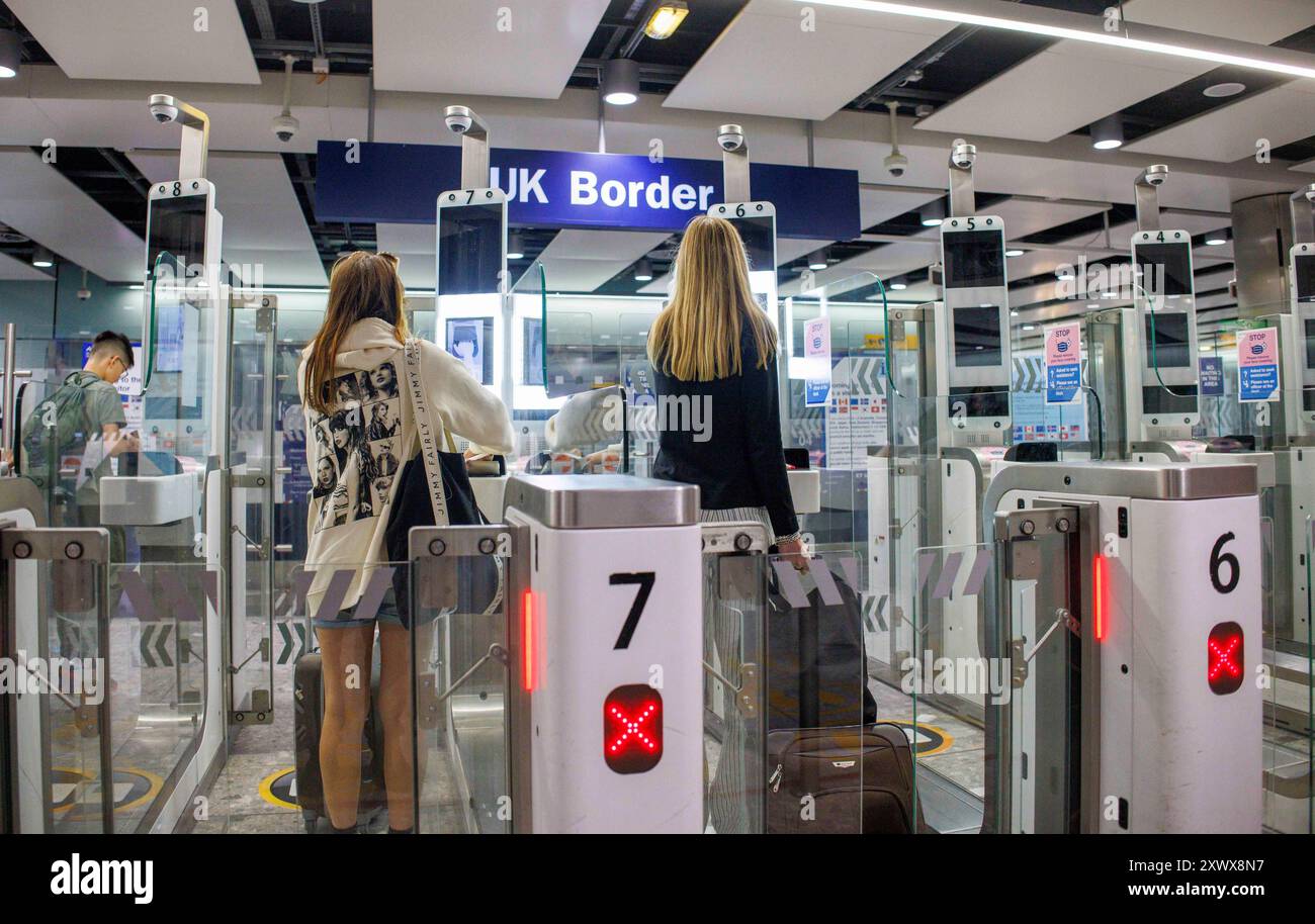 Air passengers arriving at the UK Border check-in gate at Heathrow ...