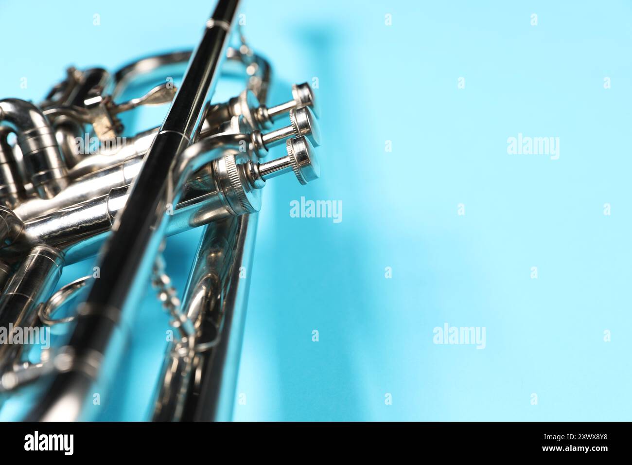 One trumpet on light blue background, closeup. Space for text Stock ...