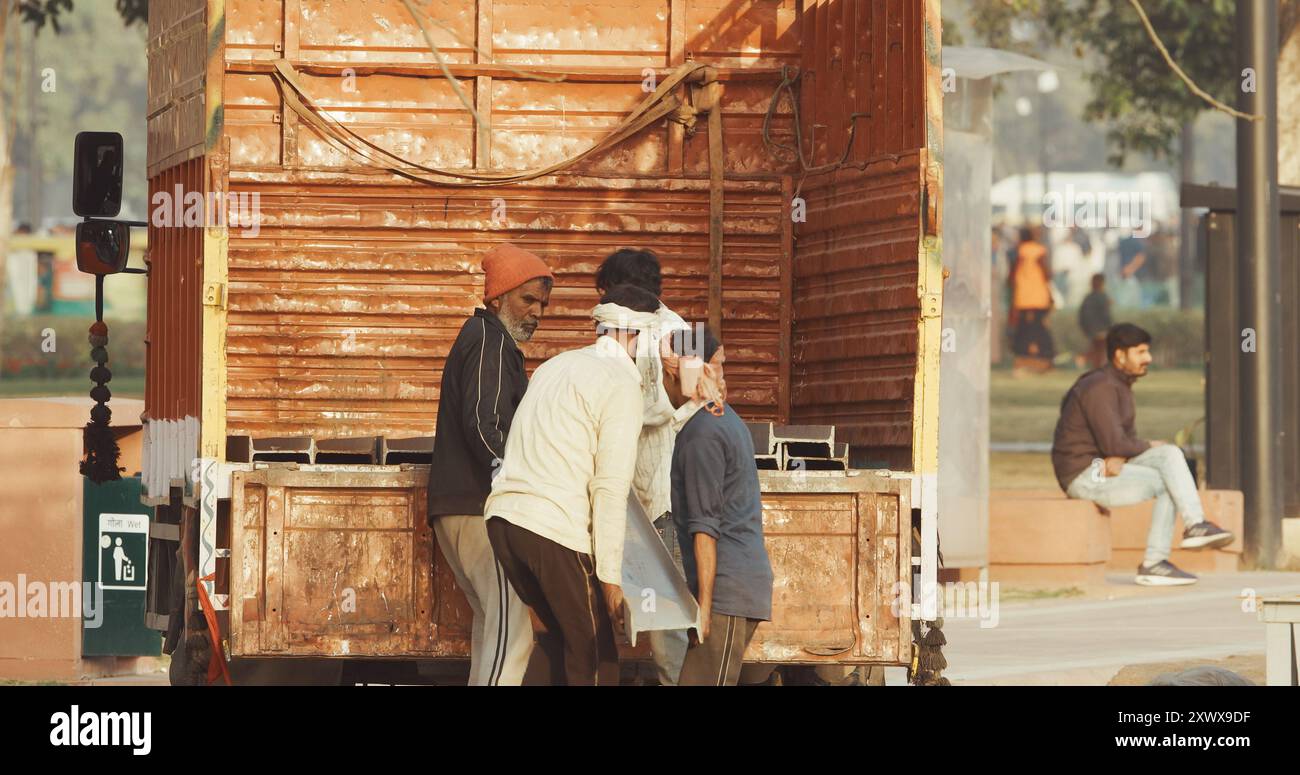 New Delhi, Delhi, India. Indian men loading heavy iron structures into ...