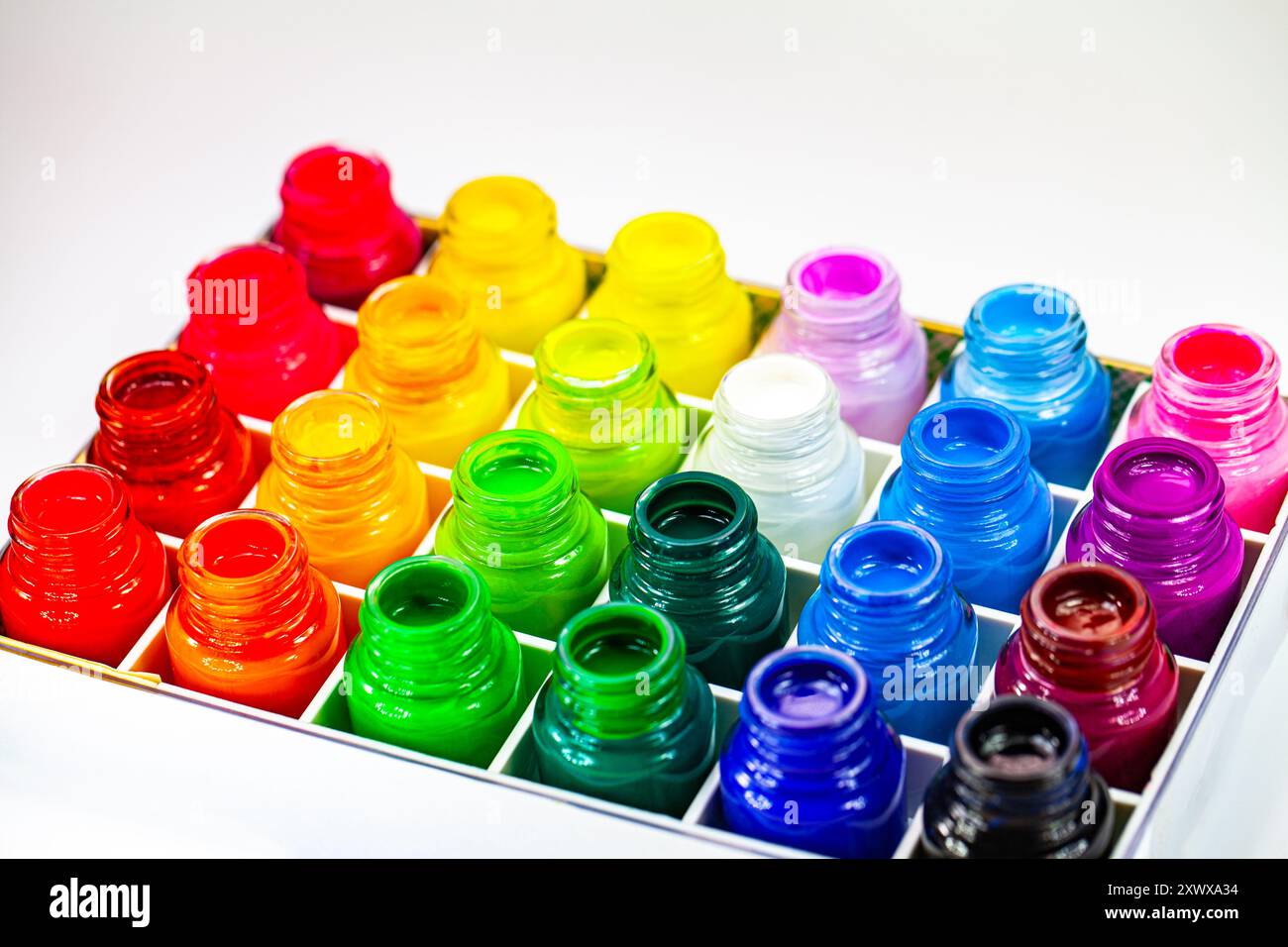 A vibrant display of various colored ink bottles arranged in a grid ...