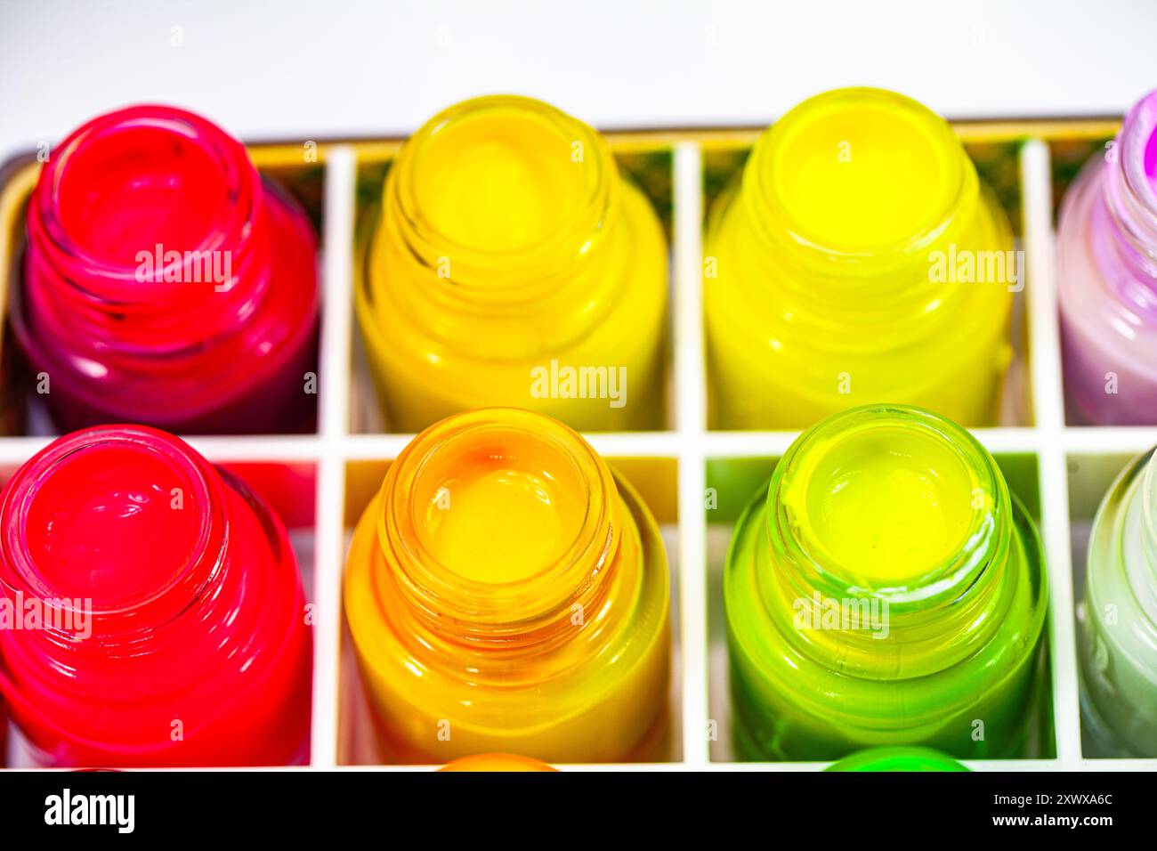 A vibrant display of various colored ink bottles arranged in a grid ...