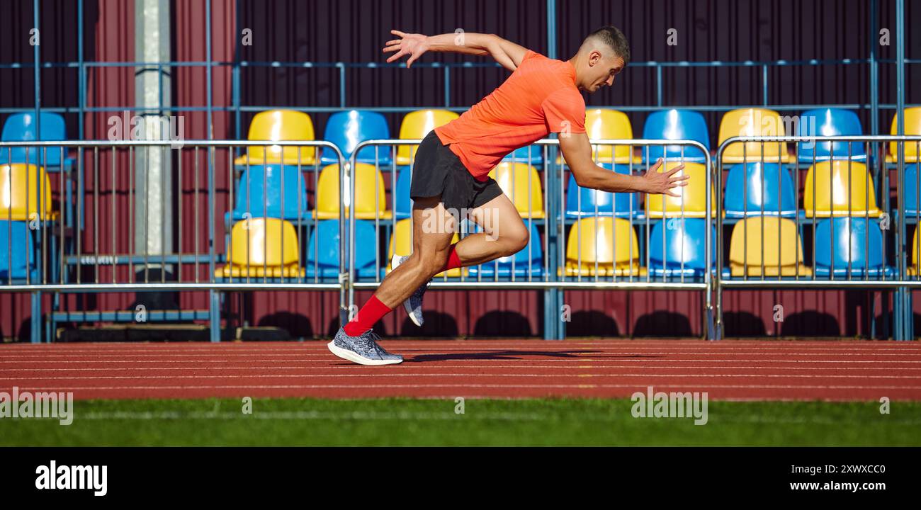 Racing past empty stands, runner in red focuses on speed and power ...