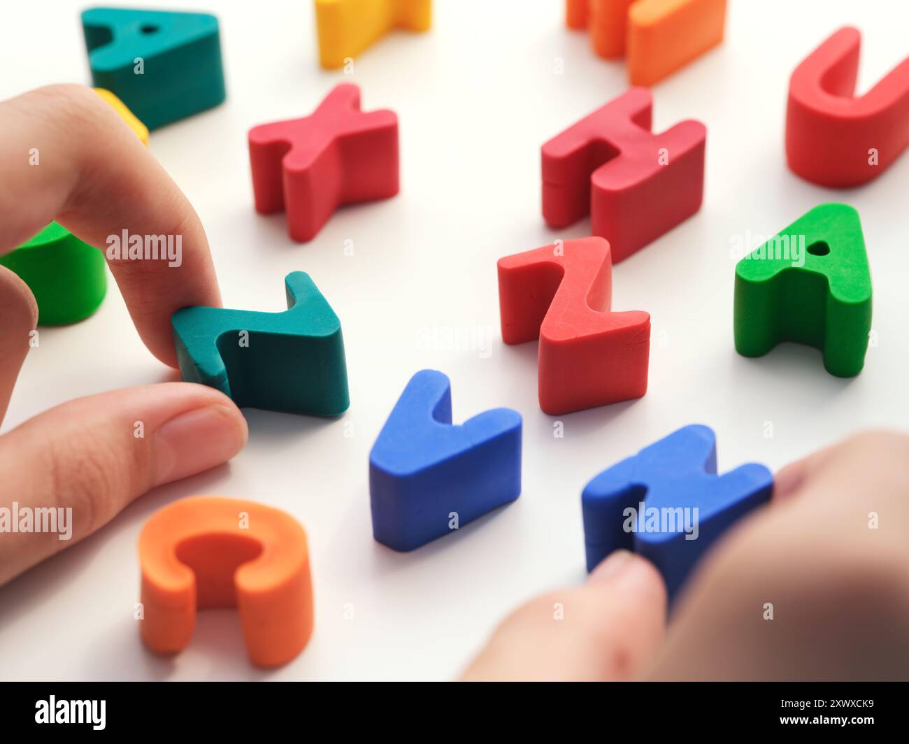 A young boy with dyslexia trying to spell a word with letters. Close up ...