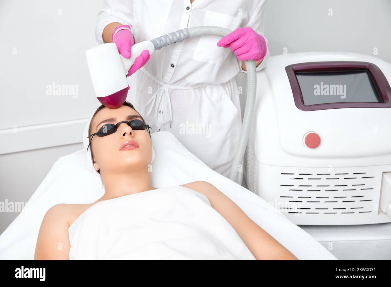 Elos epilation hair removal procedure on the face of a woman ...
