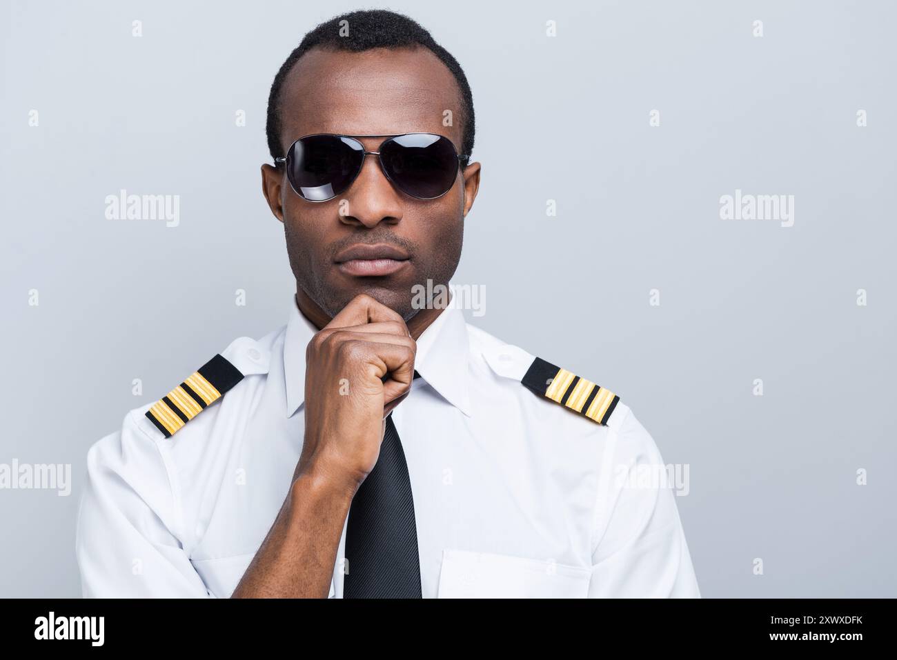 Confident and experienced pilot. Confident African pilot in uniform ...