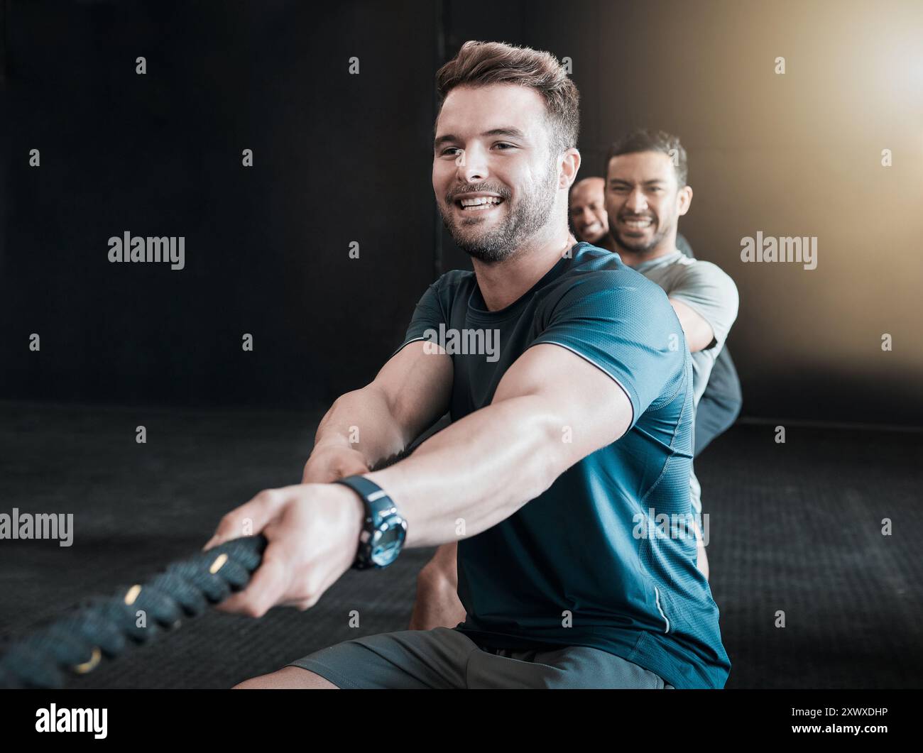 Exercise, pull and rope with people in gym together for tug of war ...