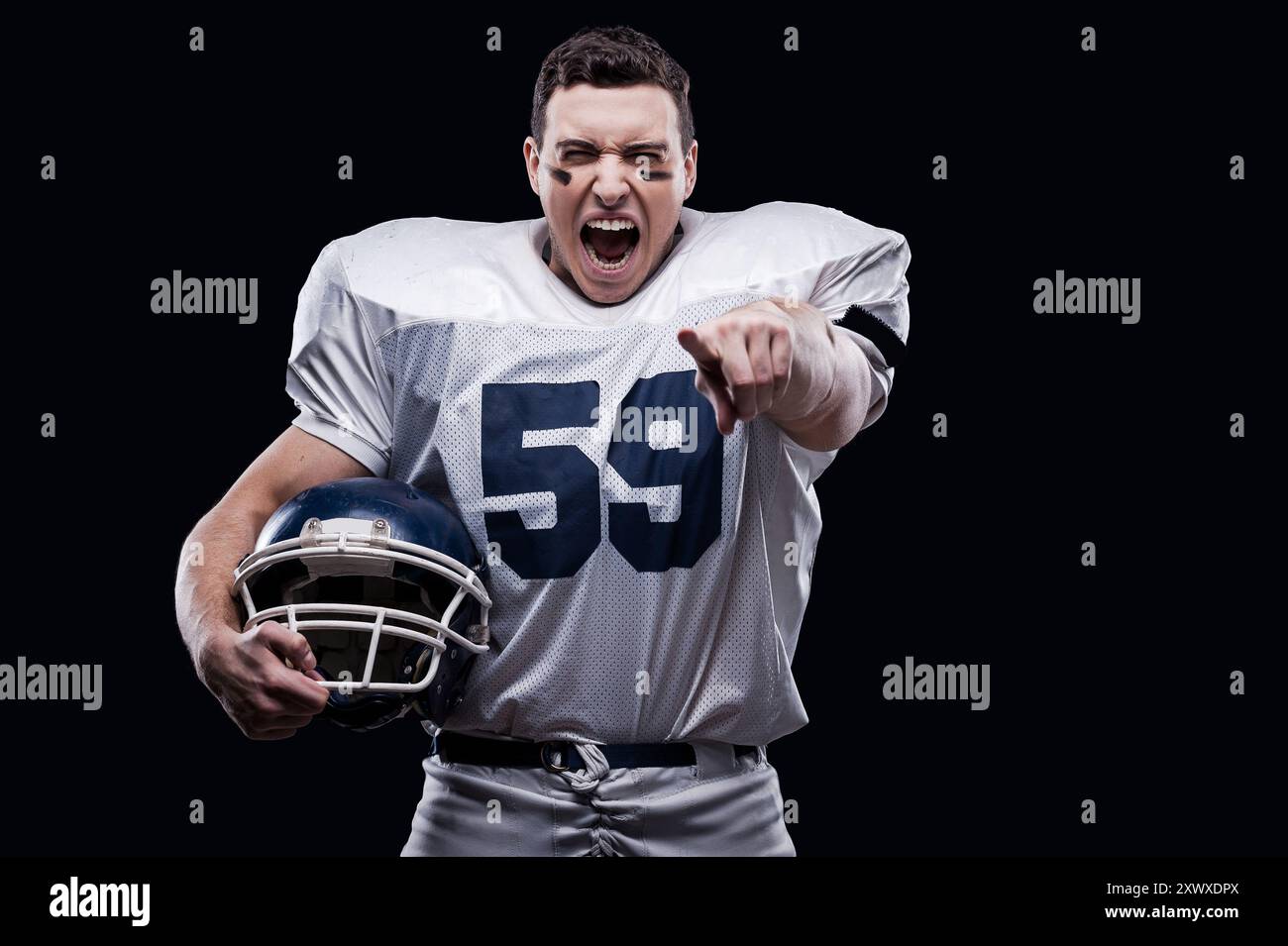 Unleashed emotions. American football player screaming and pointing at ...