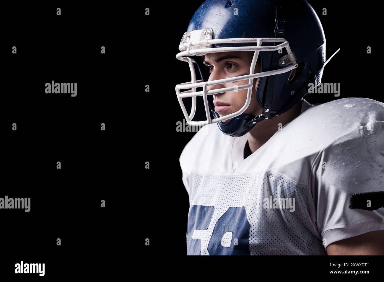 Concentrated on game. Side view of American football player looking ...
