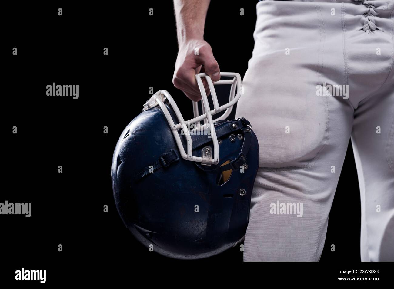Crash helmet. Cropped image of American football player holding ...