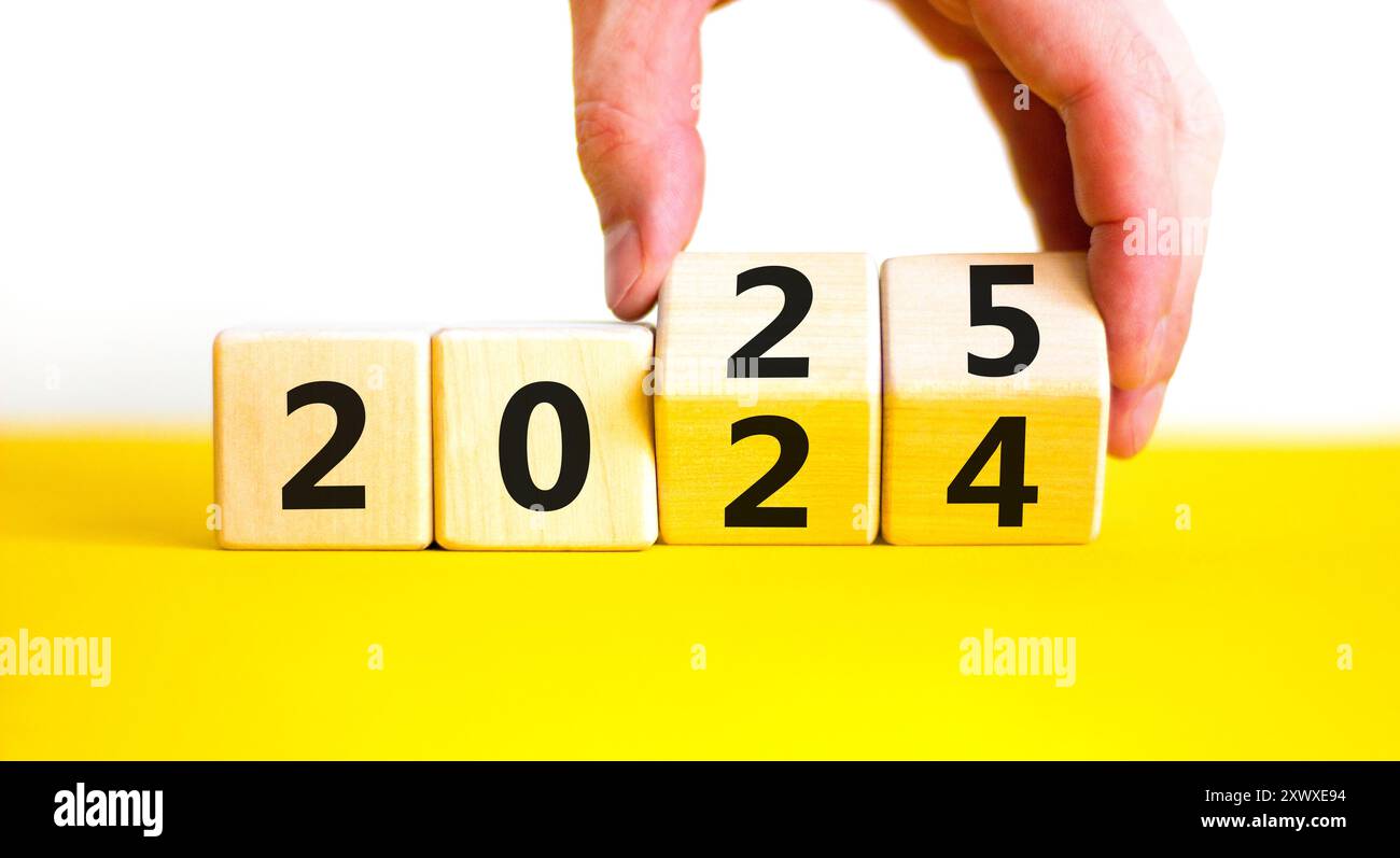 Business concept of 2025 new year symbol. Businessman turns wooden cube ...