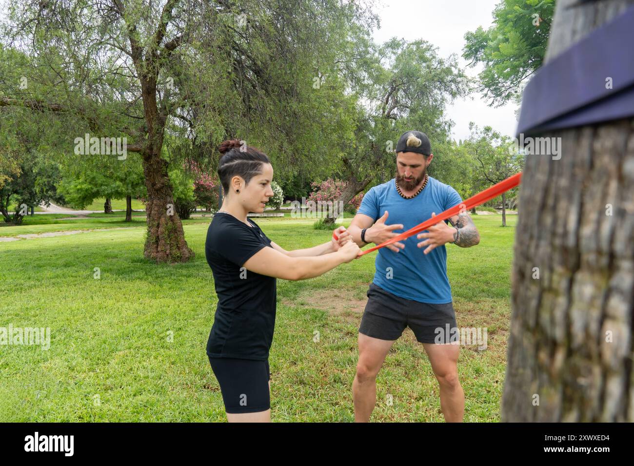 Two individuals performing a strength training exercise using ...