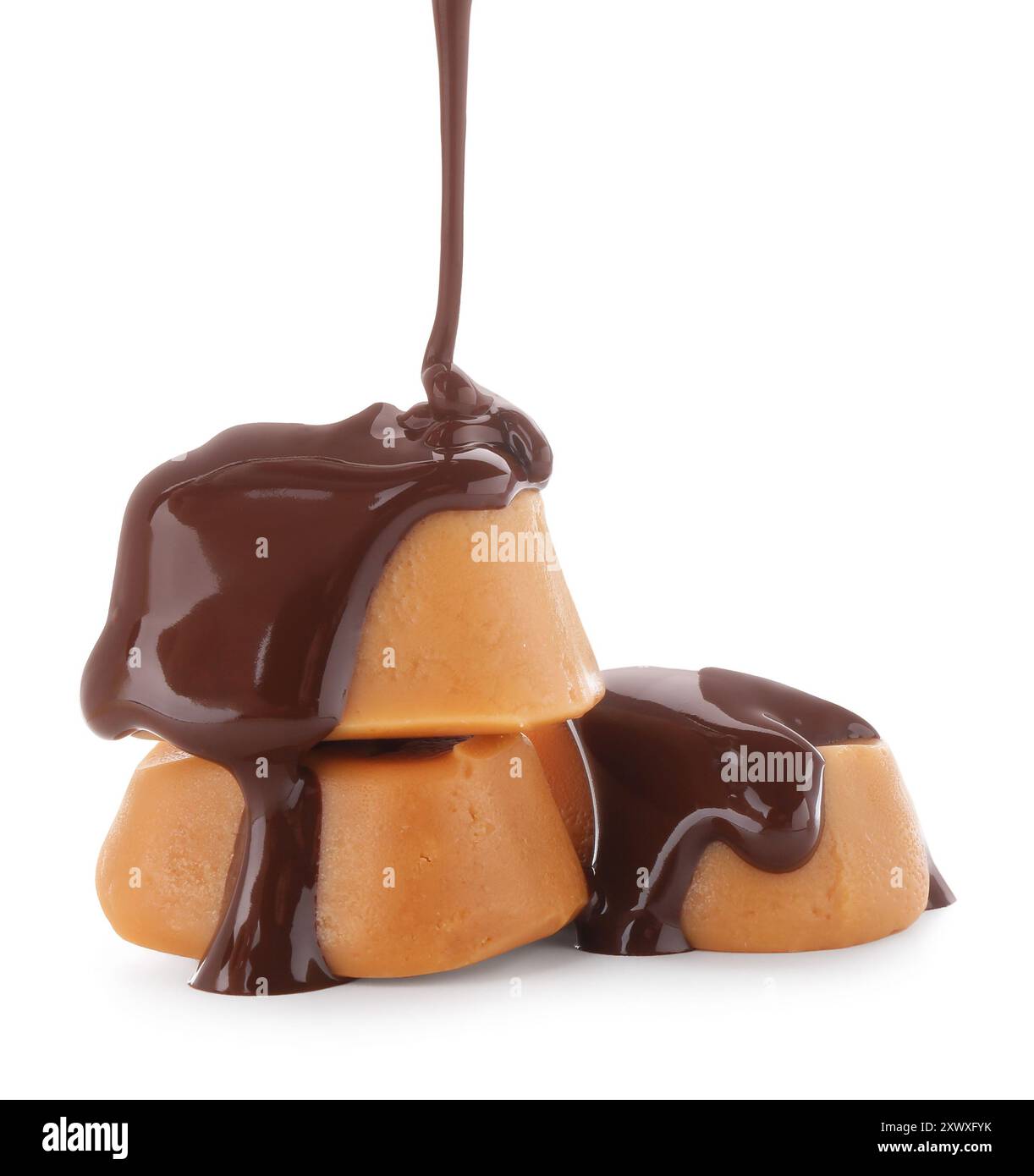 Pouring delicious melted chocolate onto caramel candies isolated on ...