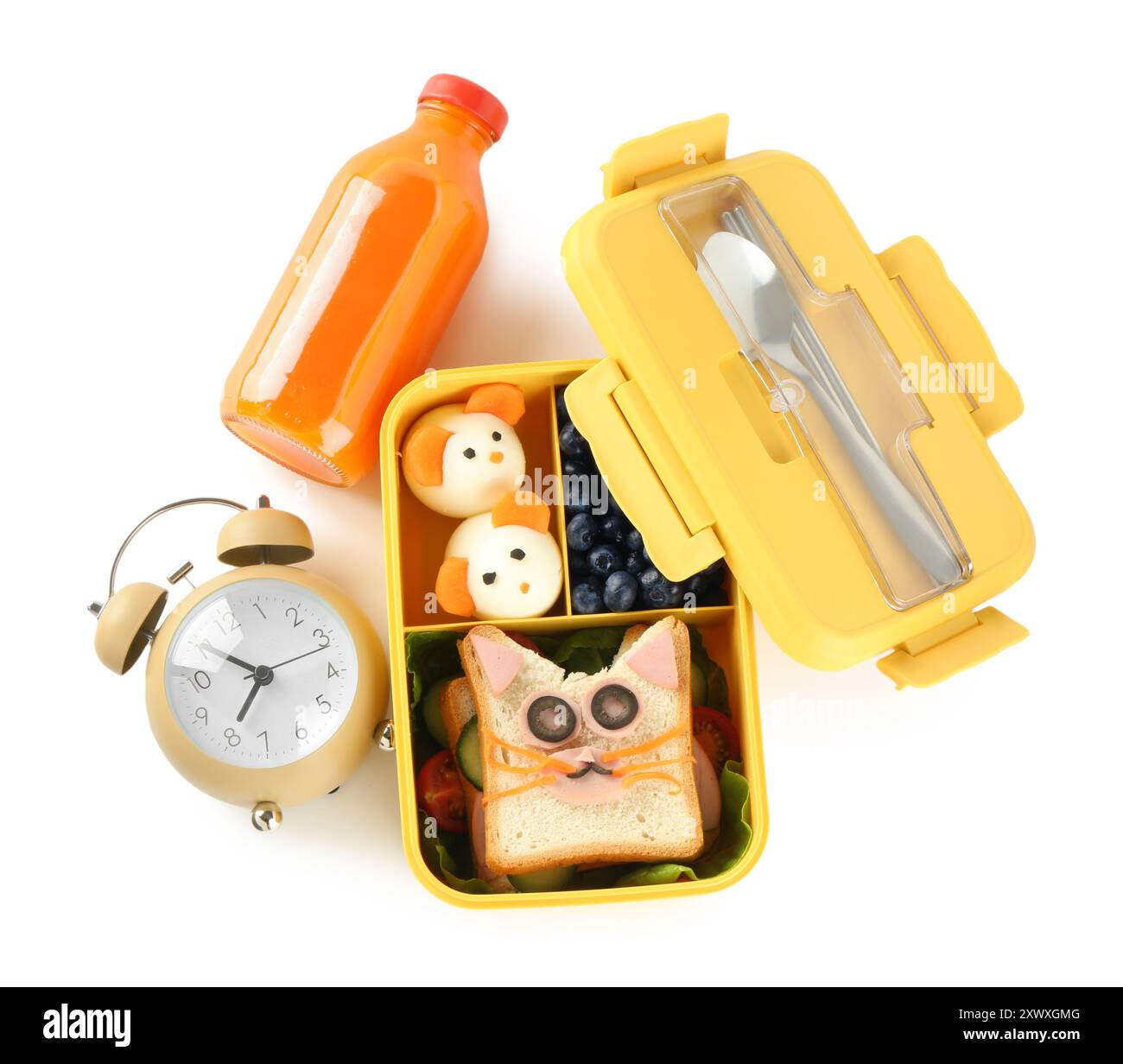 Lunch box with snacks, bottle of juice, cutlery and alarm clock ...