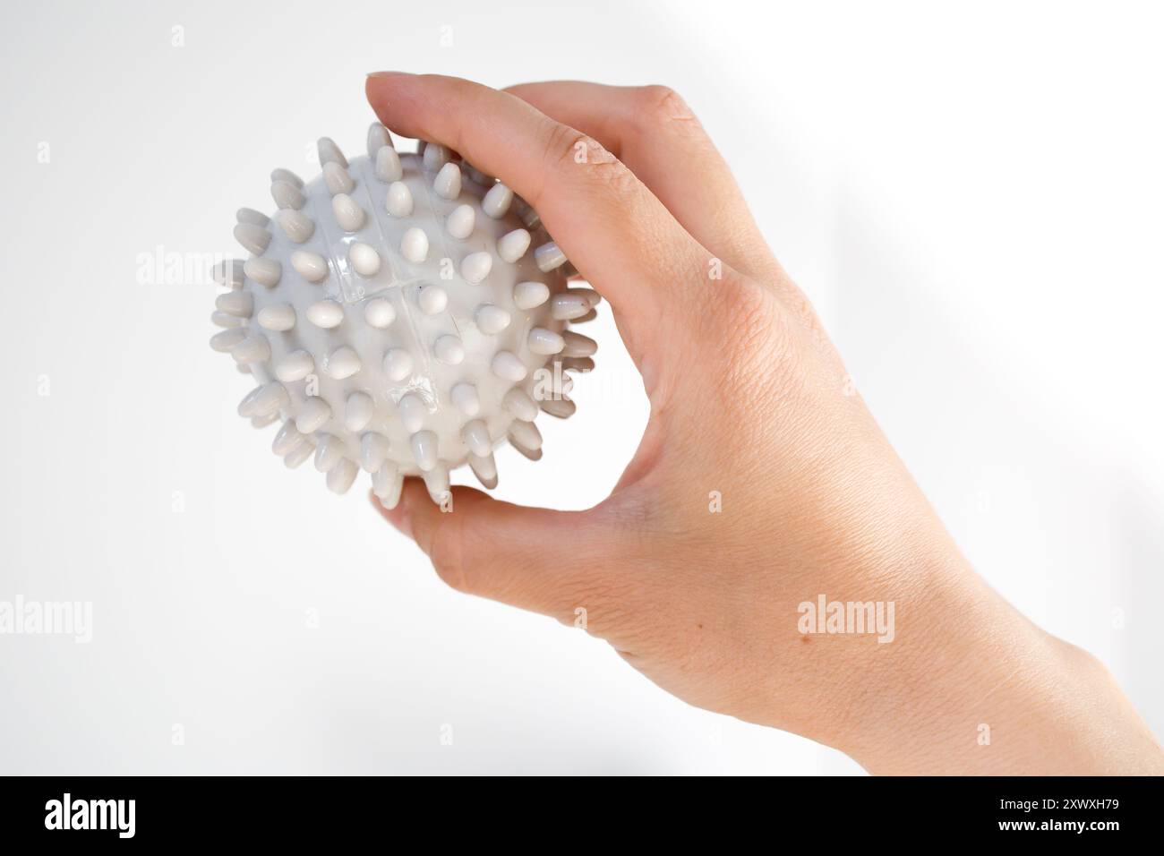 Lymphatic drainage massage spike ball in the hand Stock Photo - Alamy