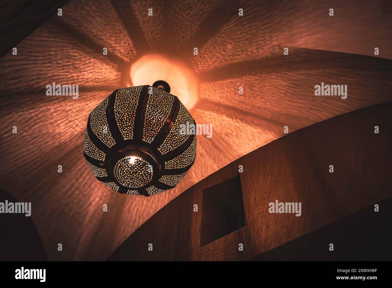 Traditional brass Moroccan Pendant Light Casting Intricate Shadows on ...