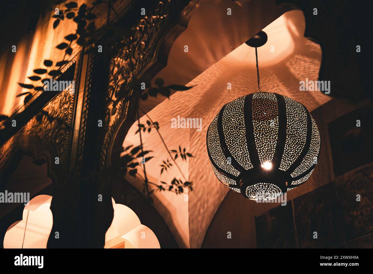 Traditional brass Moroccan Pendant Light Casting Intricate Shadows on ...