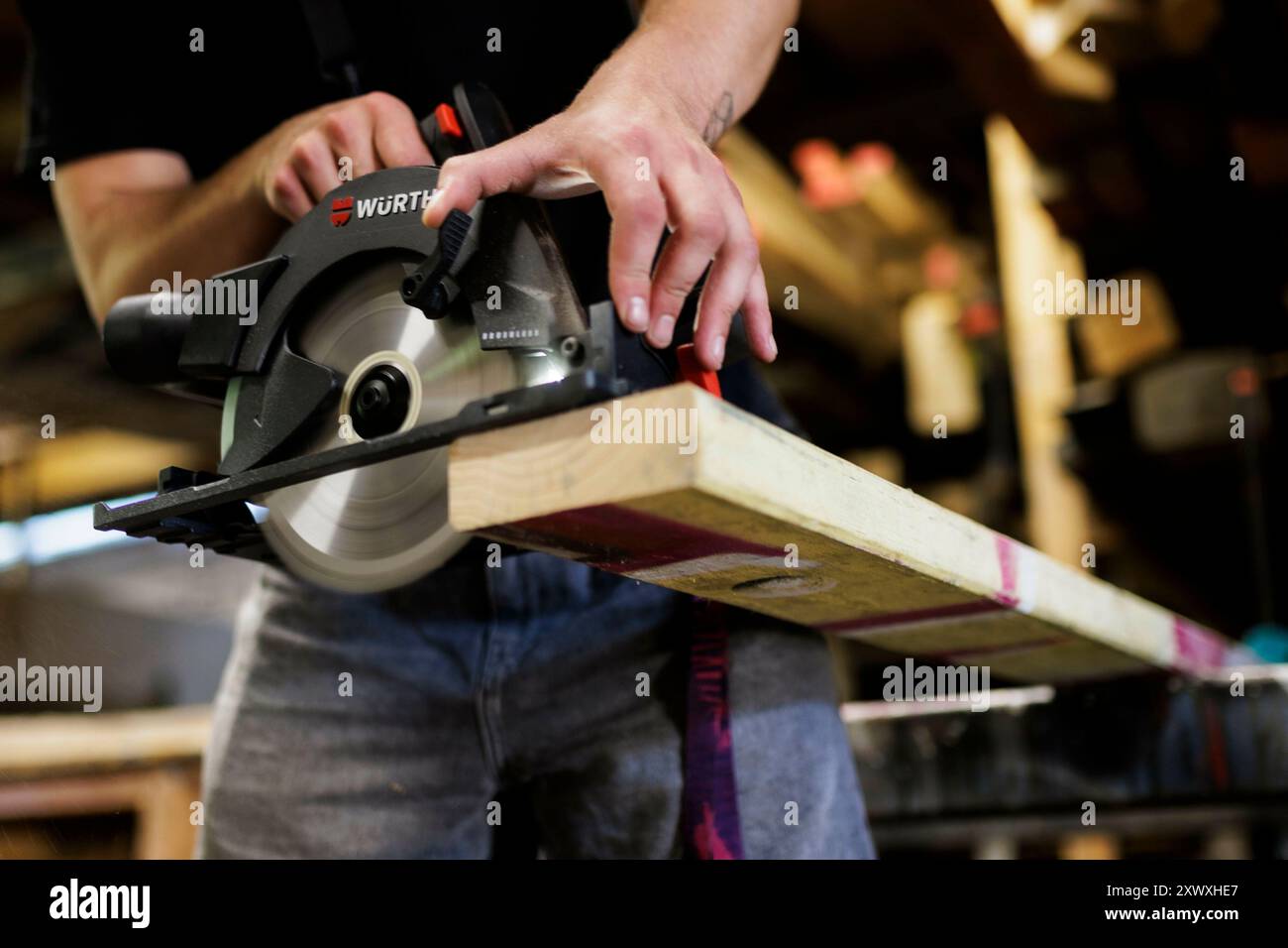 A man cuts wood with a circular saw. Berlin, August 14, 2024 Stock ...