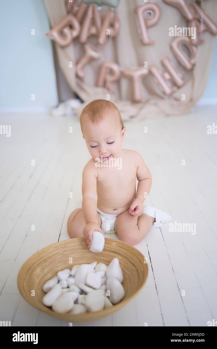 a photo session on the first birthday of a baby girl, baby play with ...