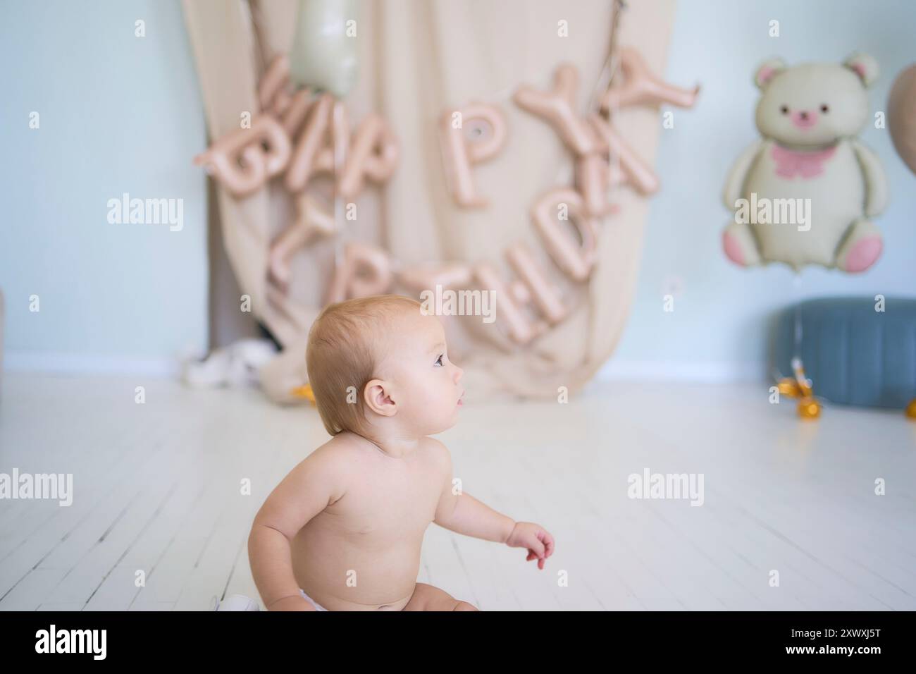a photo session on the first birthday of a baby girl, baby play with ...