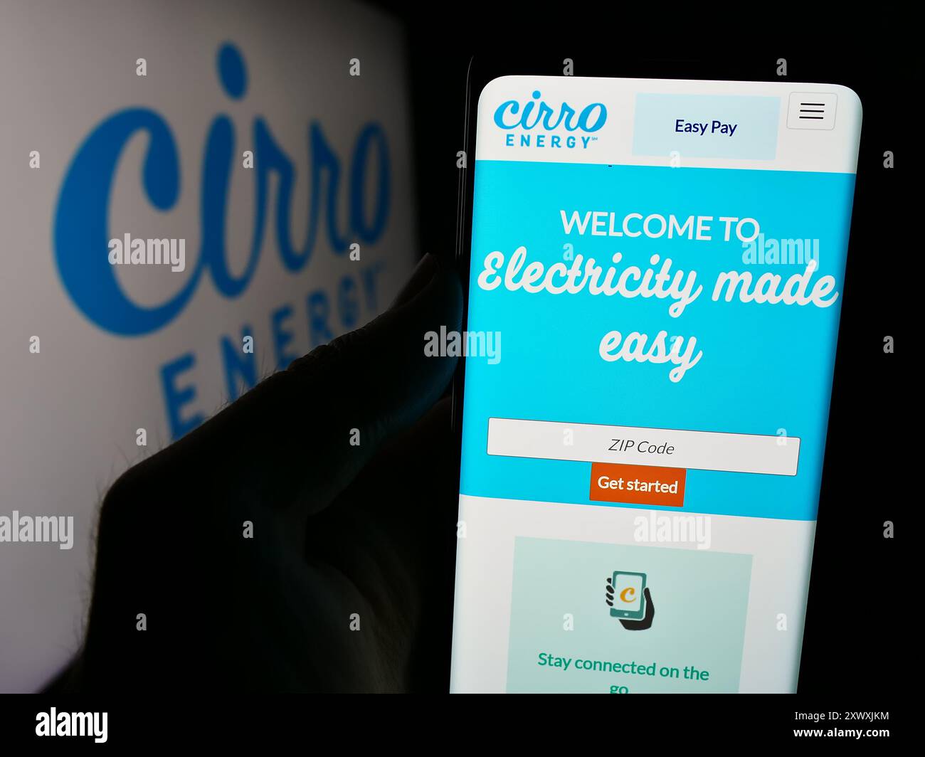 Person holding cellphone with webpage of US electricity company Cirro ...