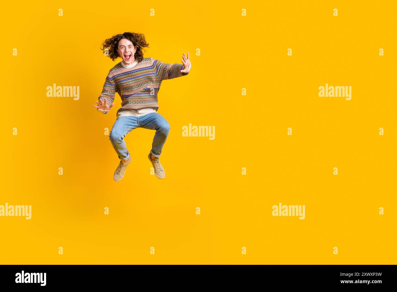 Full size photo of eccentric guy dressed ornament sweater jeans jumping ...